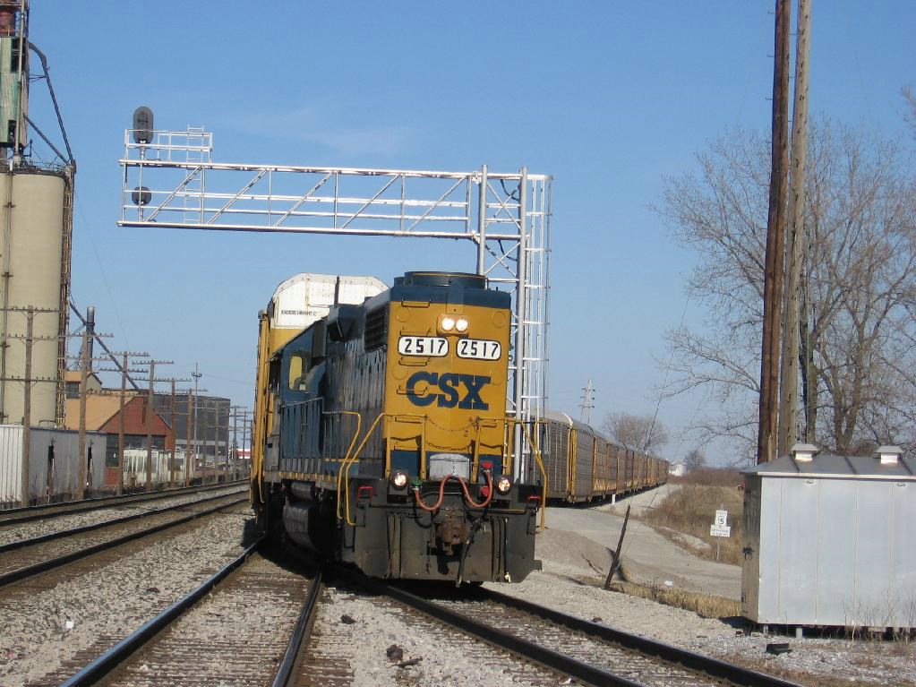 CSX 2517 leads H795 one more time towards the yard with a line of racks bound for lord knows where